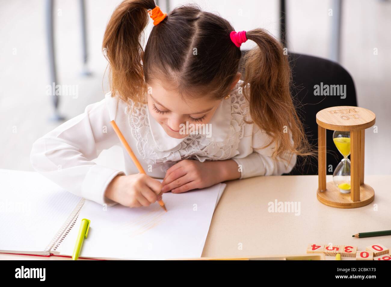 Small girl in the time management concept Stock Photo - Alamy