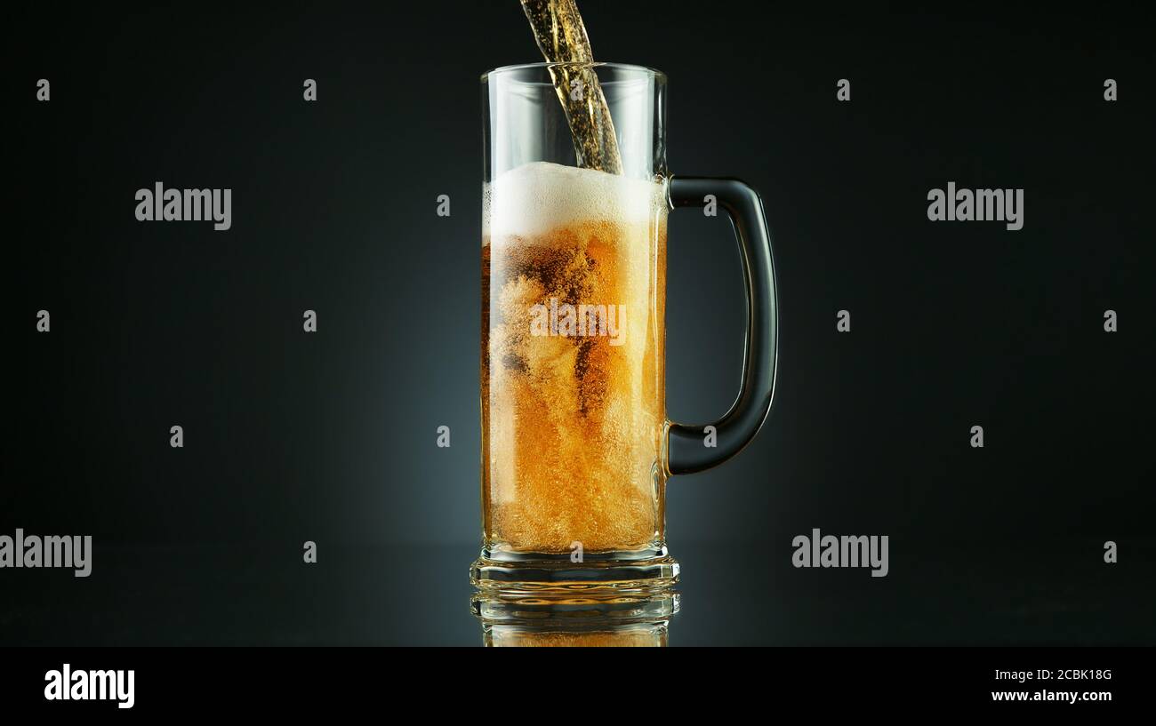 Freeze motion of pouring beer into glass pint, isolated on black ...