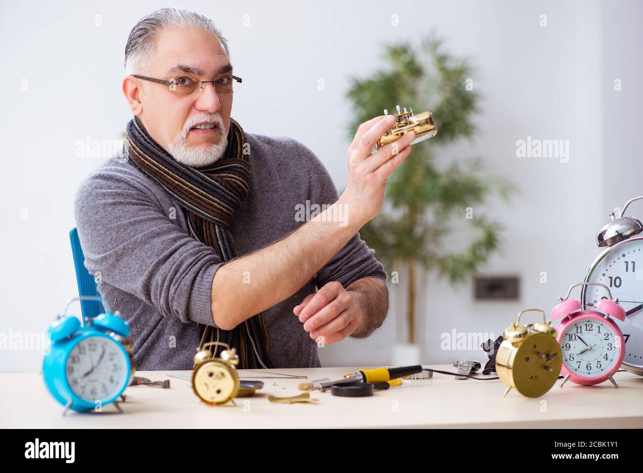 Old watchmaker working in the workshop Stock Photo - Alamy