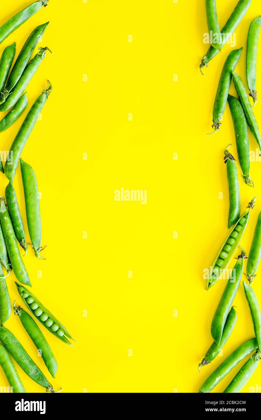 Frame of green pea pods and peas on the kitchen background Stock Photo ...