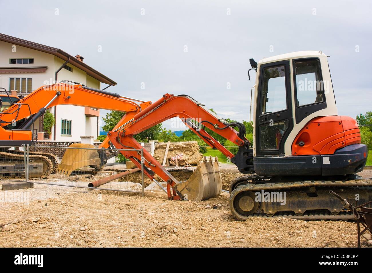 A compact crawler excavator with a rotating house platform and ...