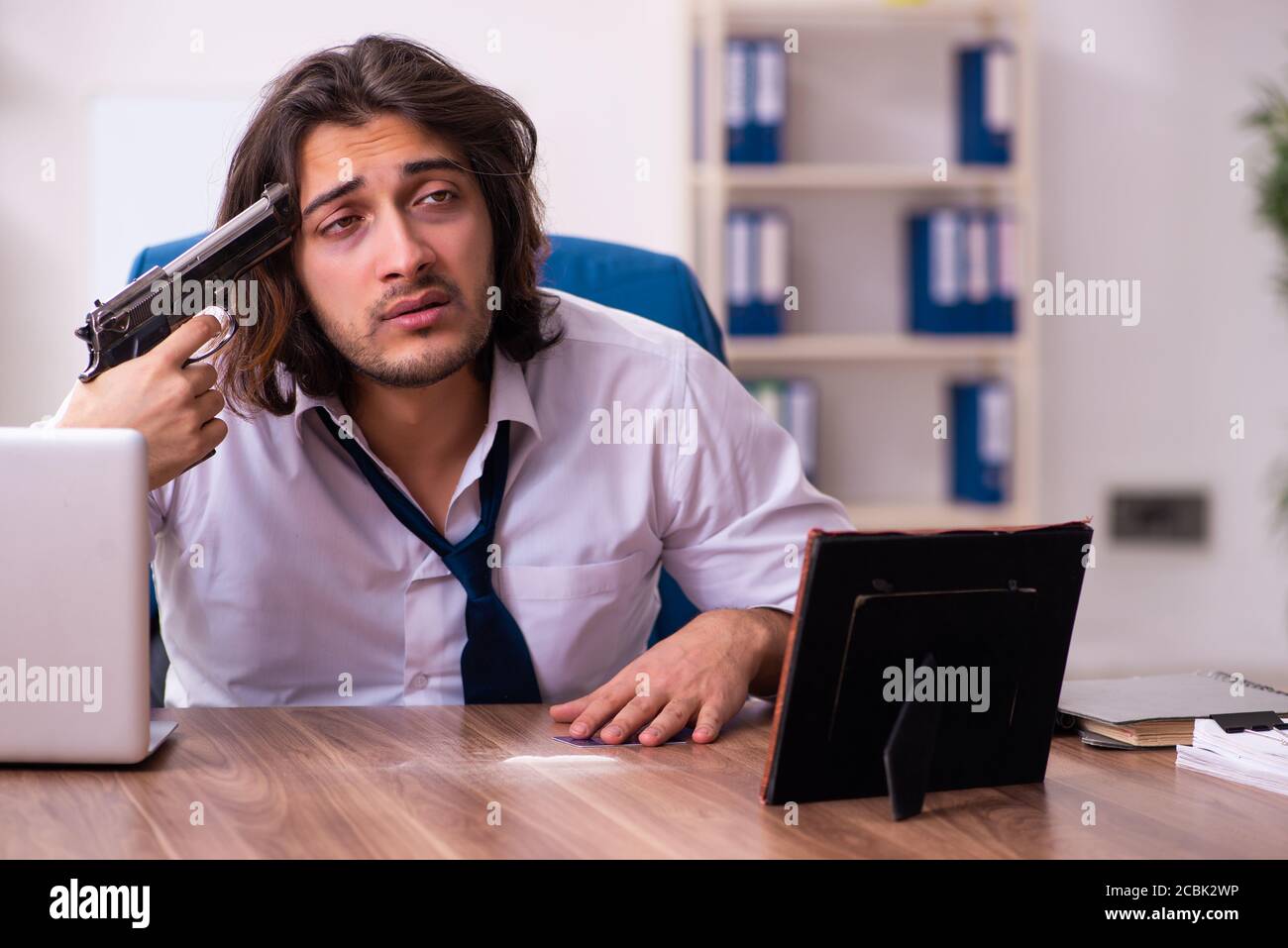 Drug addicted employee working in the office Stock Photo - Alamy