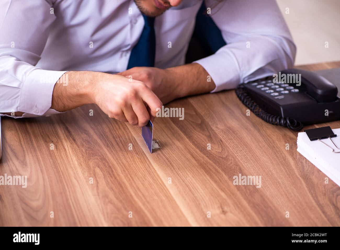 Drug addicted employee working in the office Stock Photo - Alamy