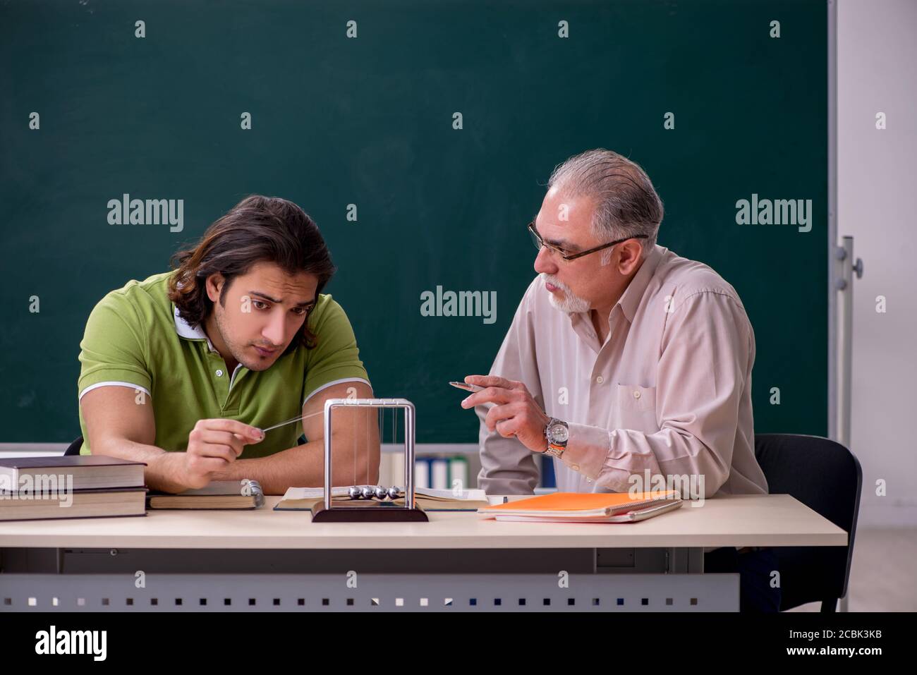 Old professor physicist and student in the classroom Stock Photo - Alamy