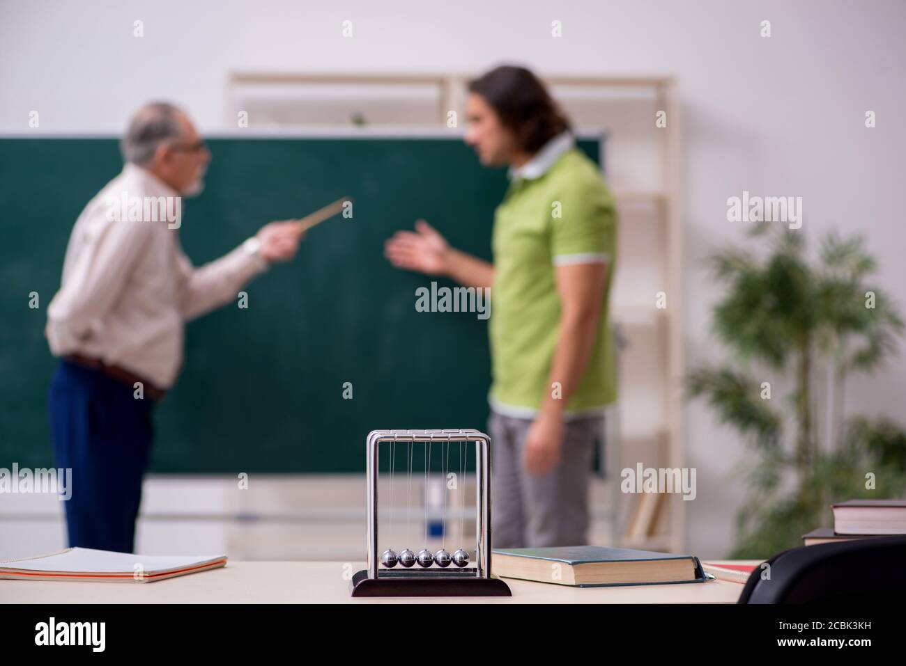 Old professor physicist and student in the classroom Stock Photo - Alamy