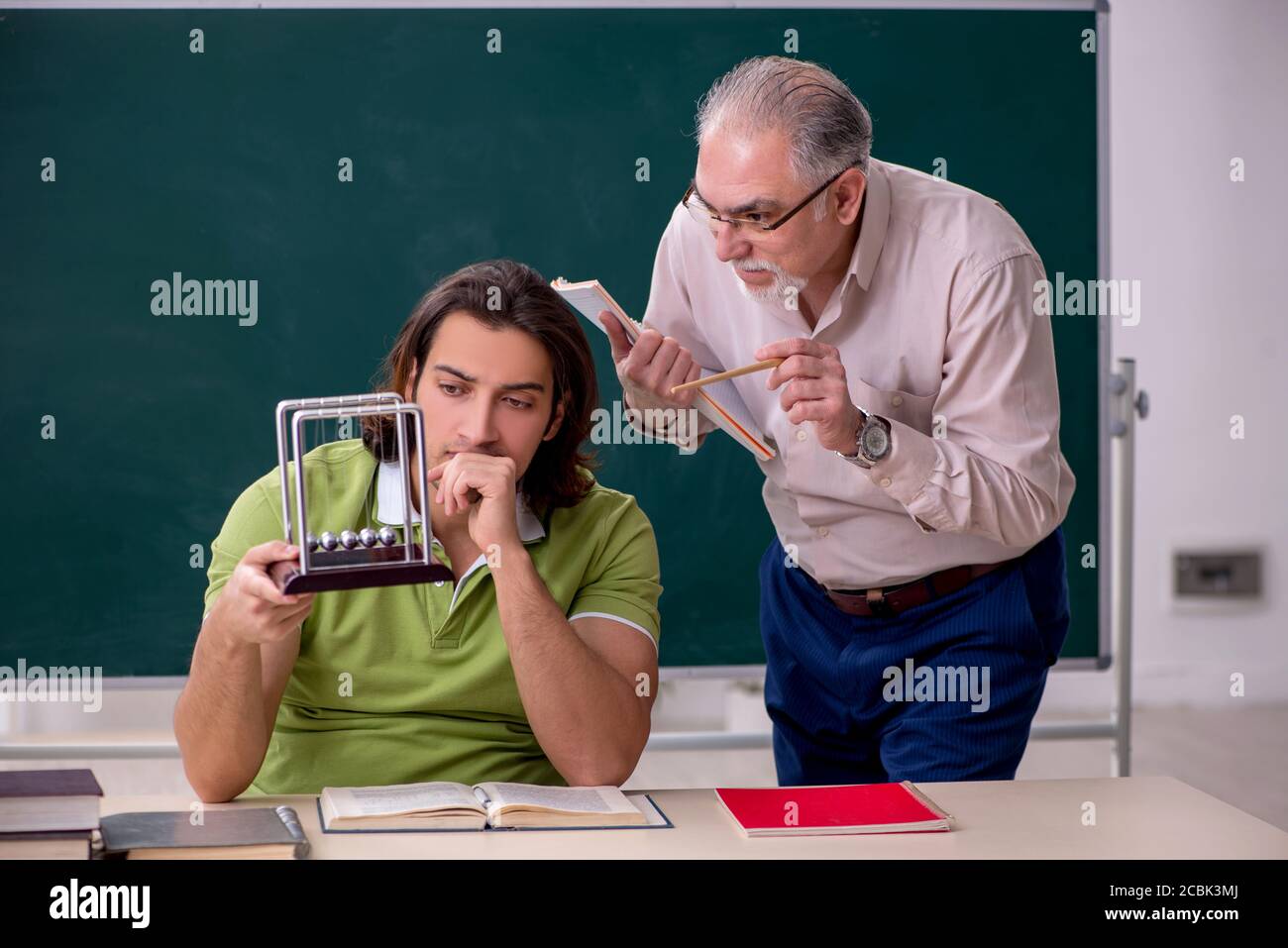 Old professor physicist and student in the classroom Stock Photo - Alamy