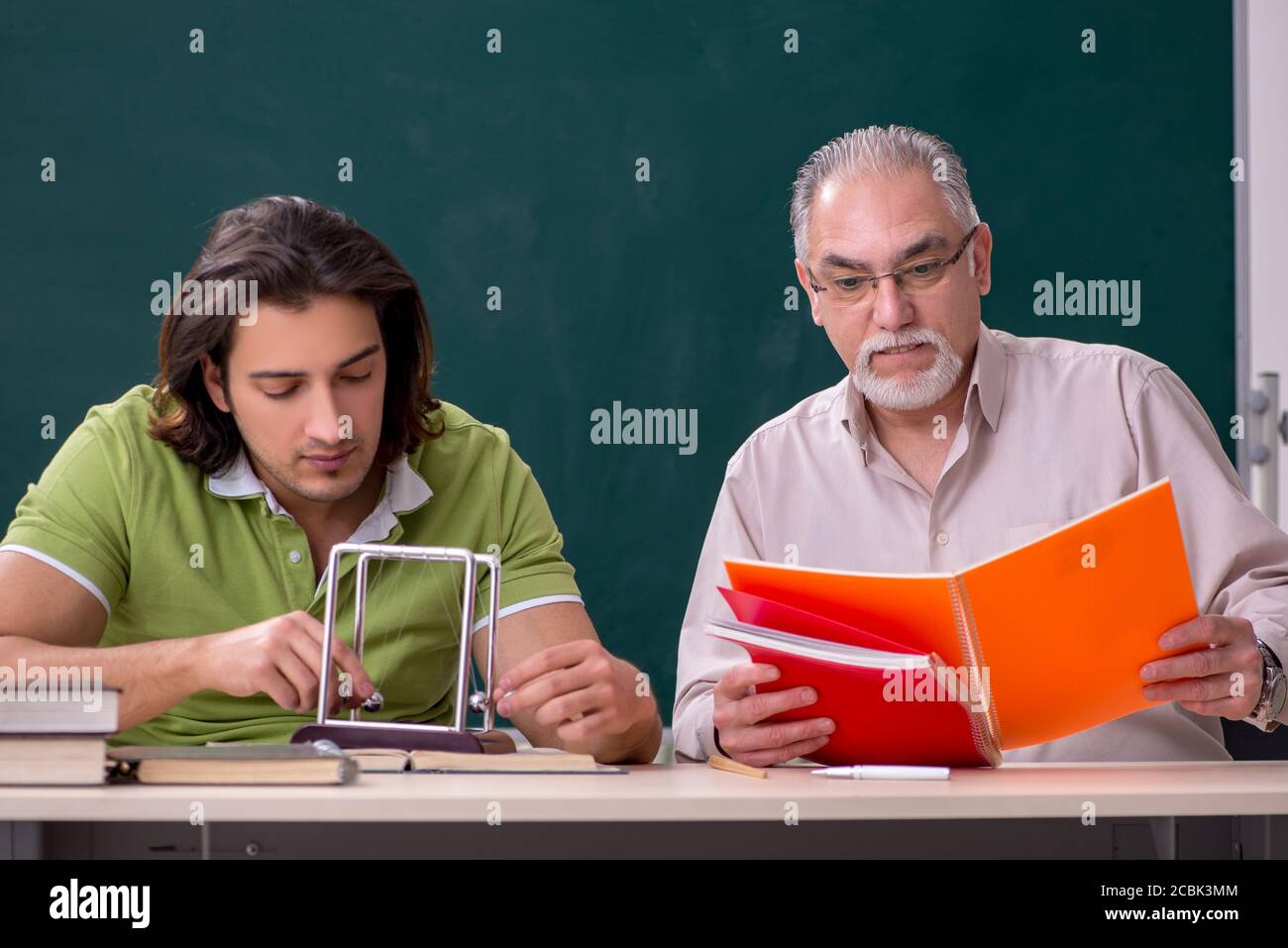 Old professor physicist and student in the classroom Stock Photo - Alamy