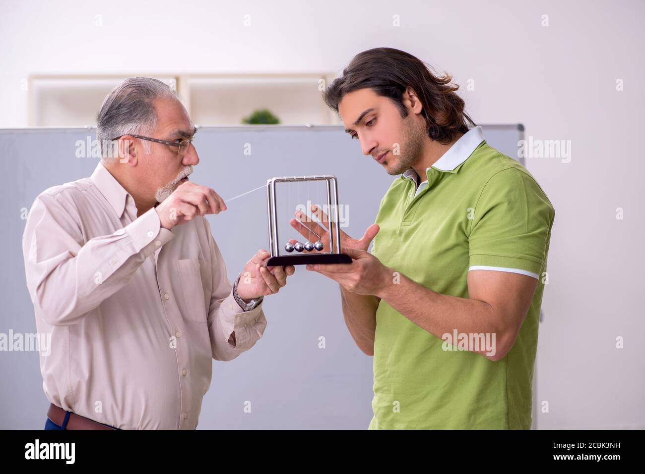 Old professor physicist and student in the classroom Stock Photo - Alamy