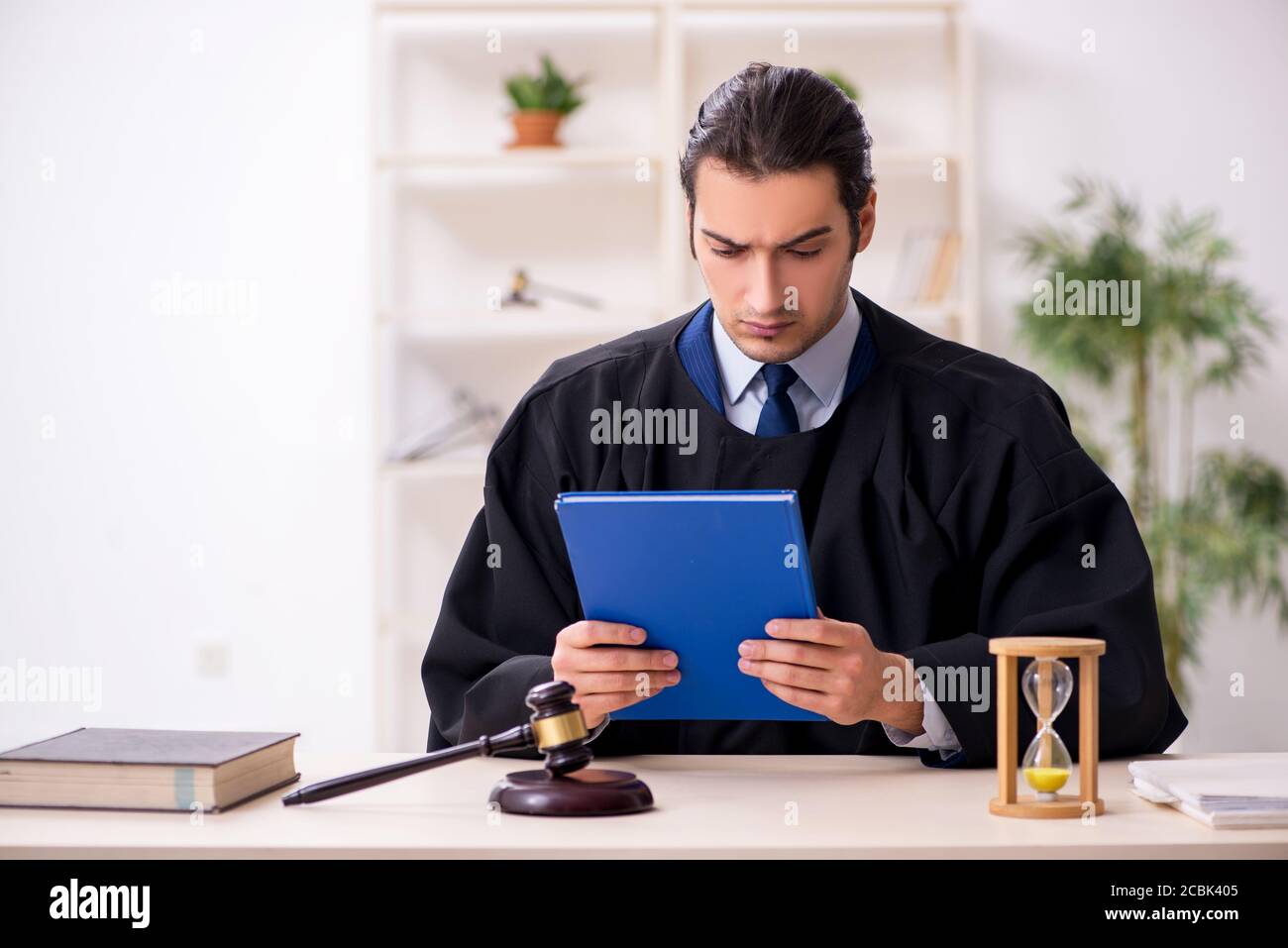 Young judge in time management concept Stock Photo - Alamy