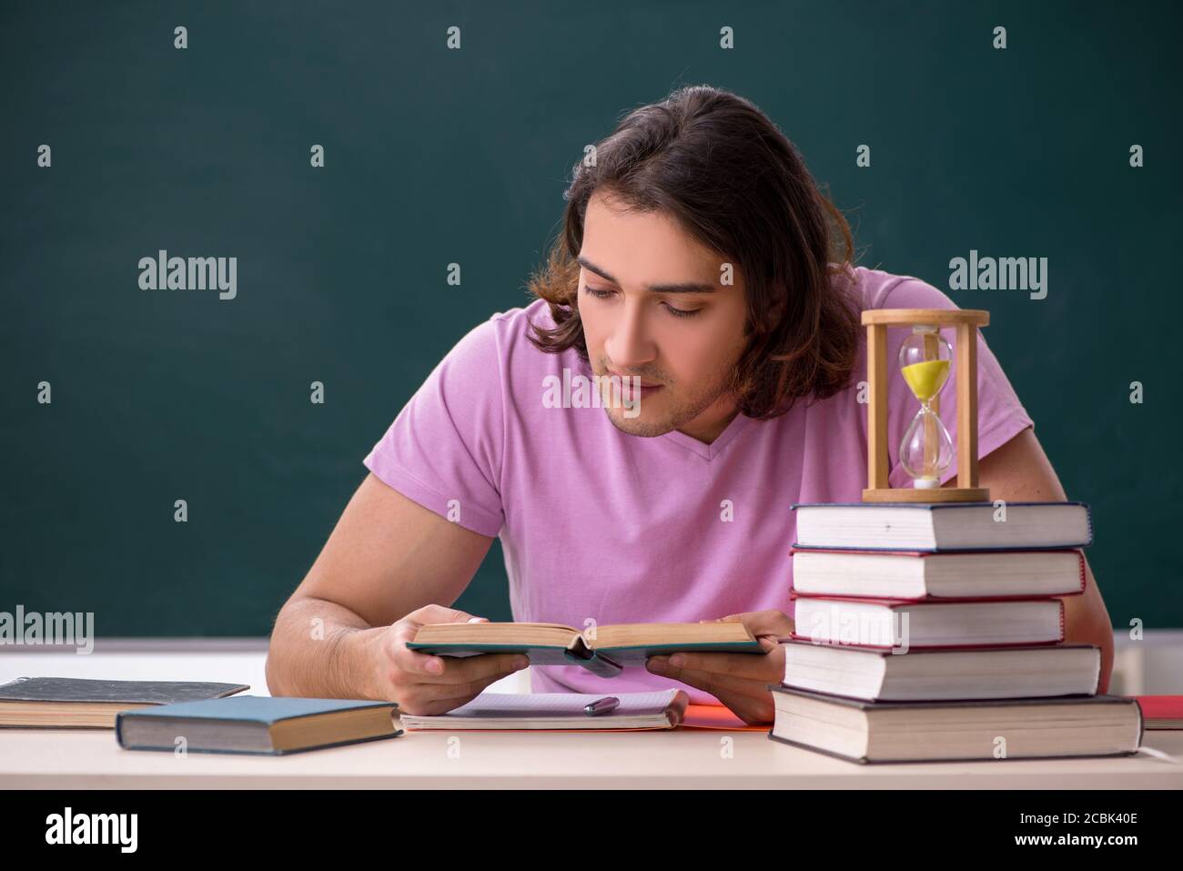 Young student in the classroom at time management concept Stock Photo ...