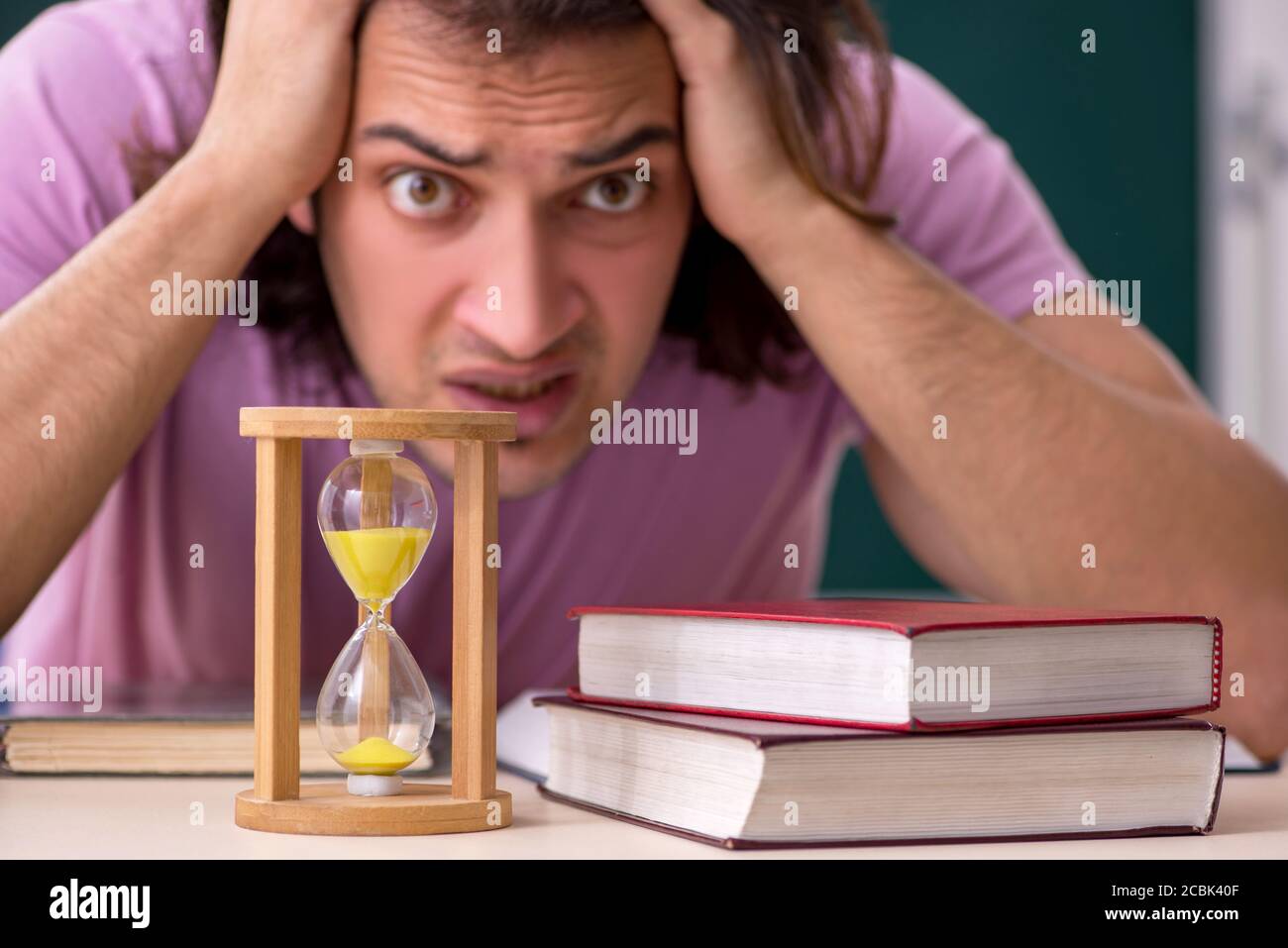Young student in the classroom at time management concept Stock Photo ...