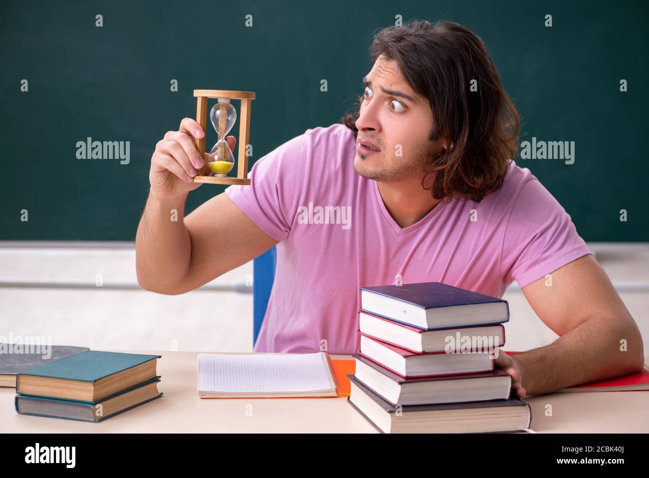 Young student in the classroom at time management concept Stock Photo ...