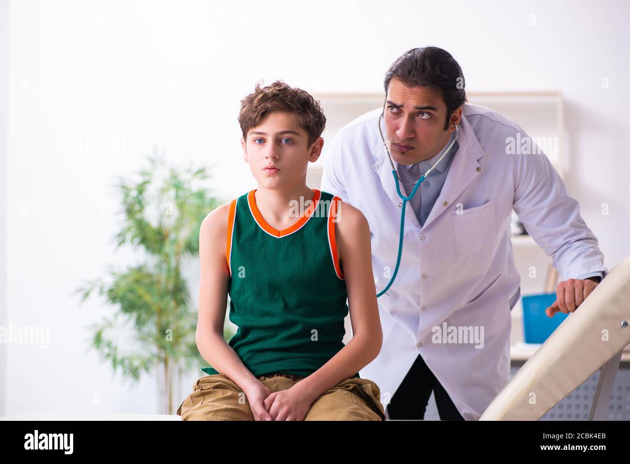 Sick boy visiting young doctor pediatrician Stock Photo - Alamy