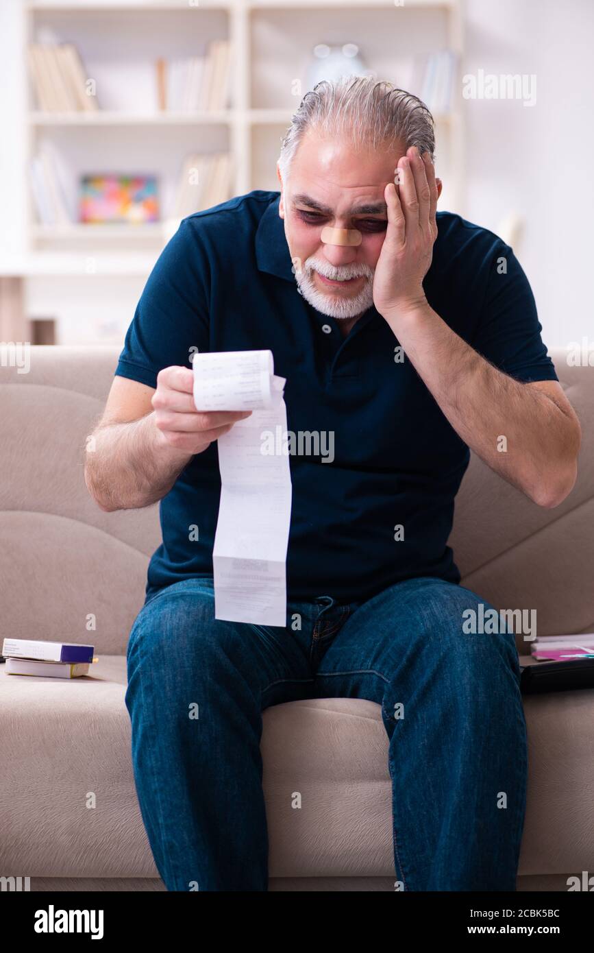 Old man in budget planning concept Stock Photo - Alamy