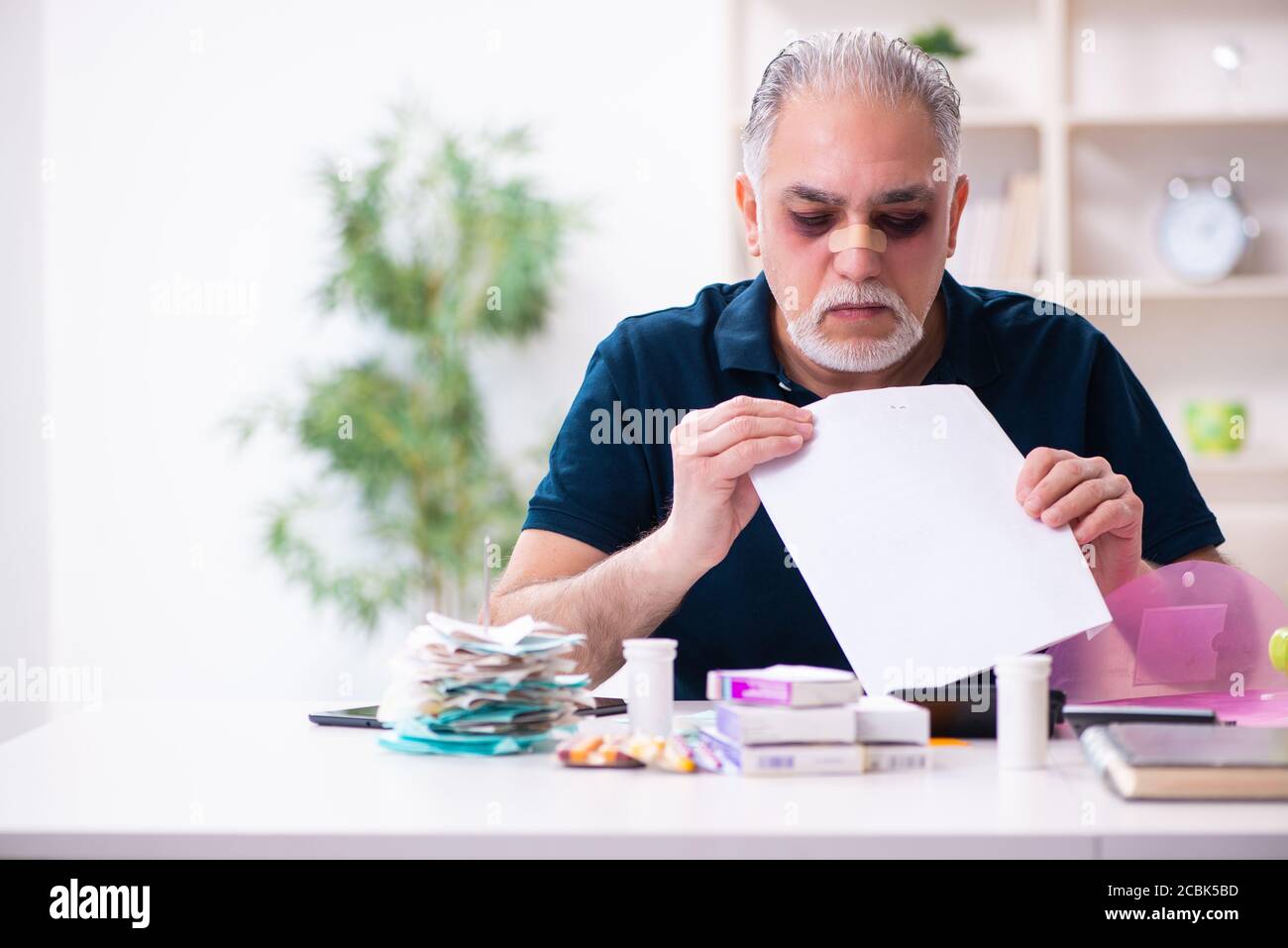 Old man in budget planning concept Stock Photo - Alamy
