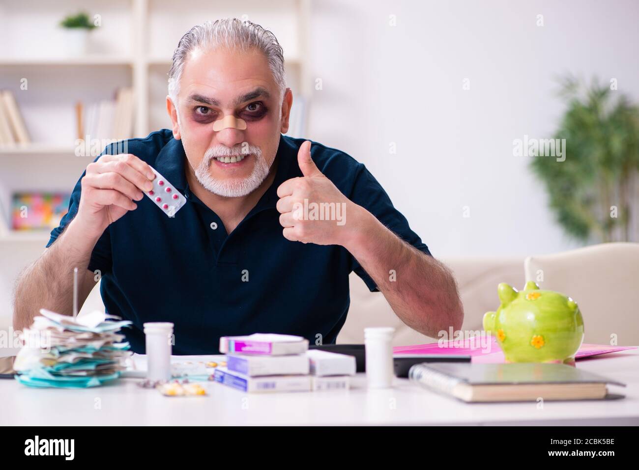 Old man in budget planning concept Stock Photo - Alamy