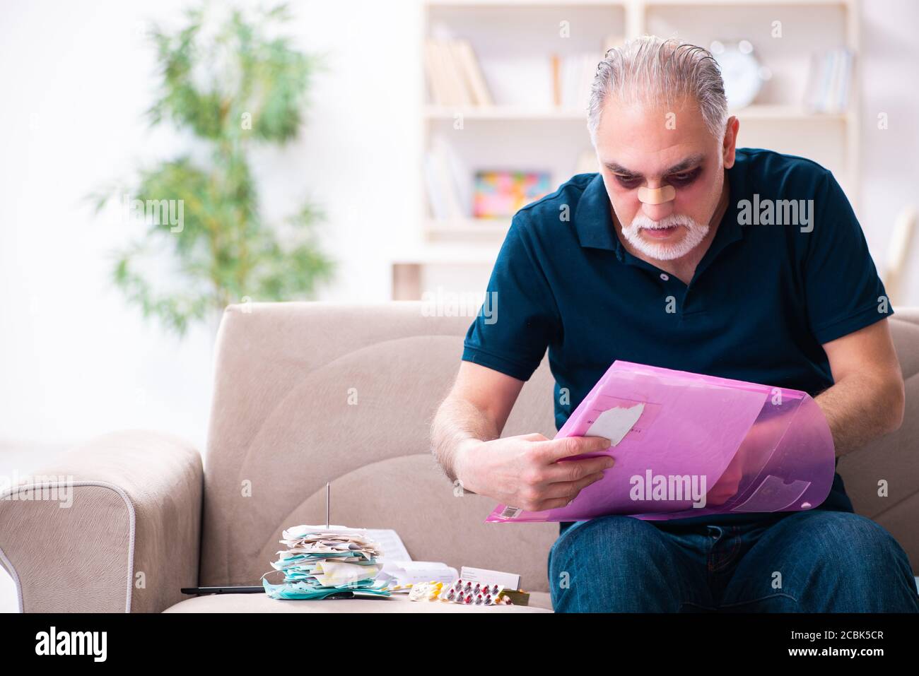 Old man in budget planning concept Stock Photo - Alamy