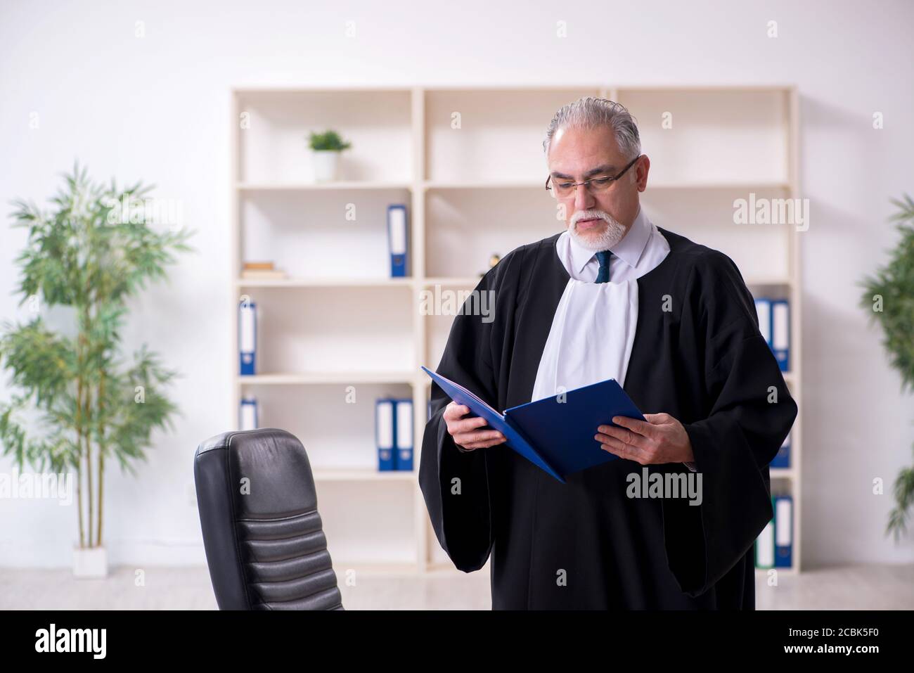 Old judge working in courthouse Stock Photo - Alamy