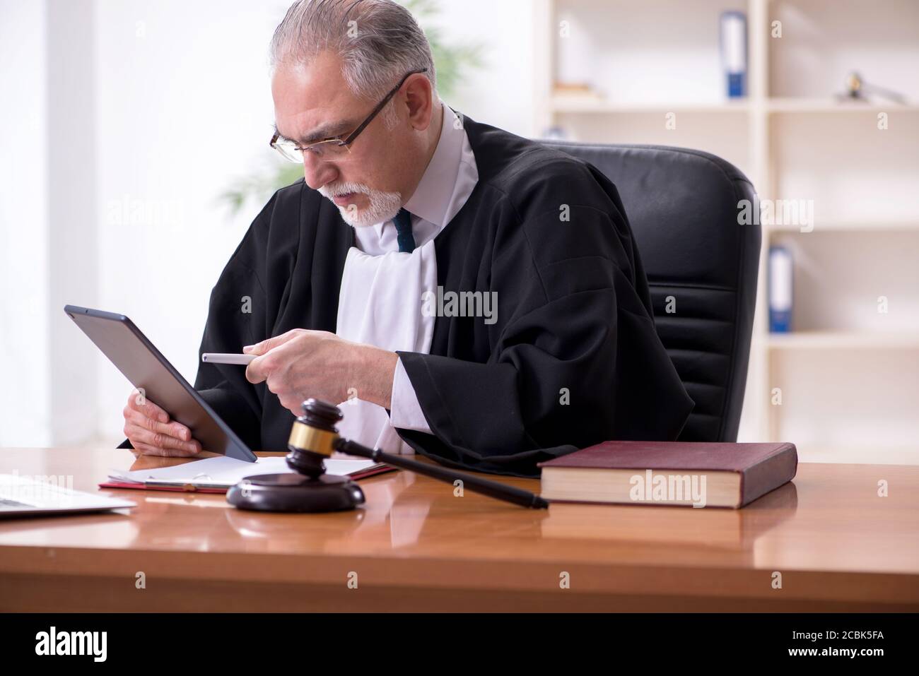 Old judge working in courthouse Stock Photo - Alamy