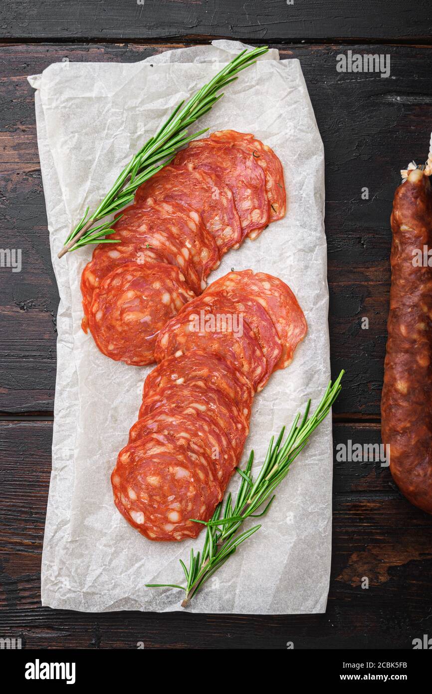 Chorizo, spanish traditional sausage cut to slices on dark wooden ...