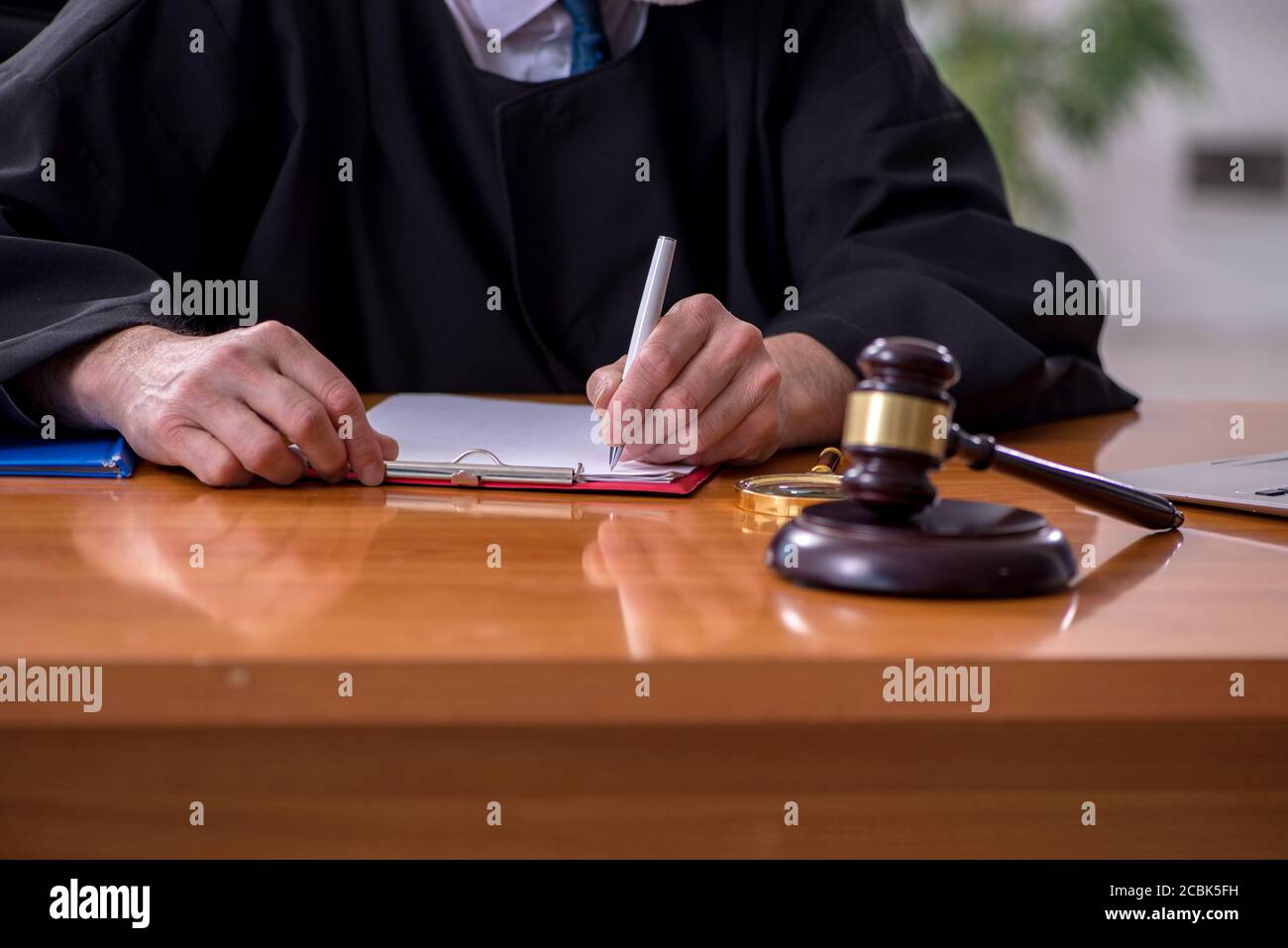 Old male judge working in the courthouse Stock Photo - Alamy