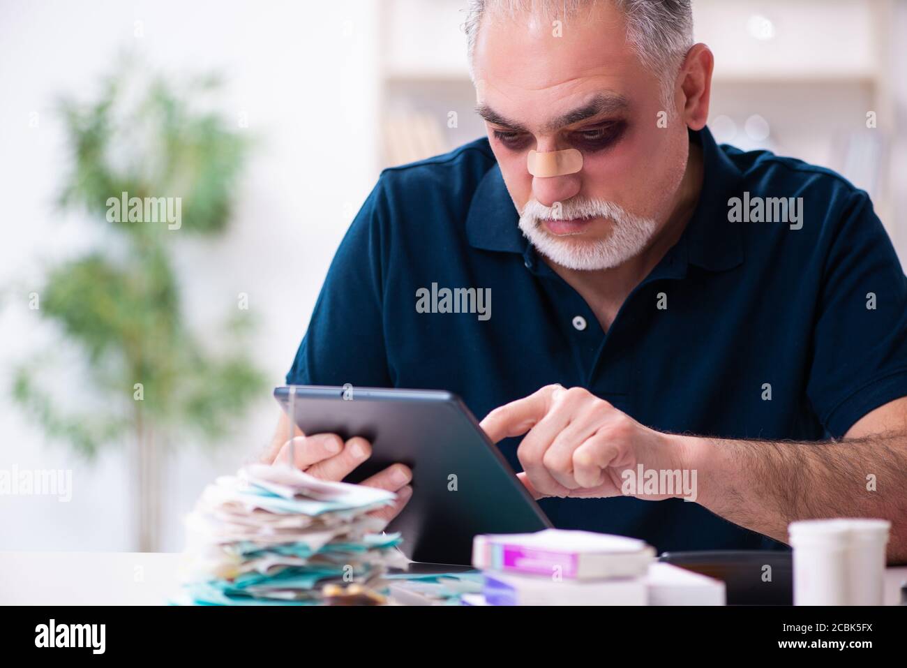 Old man in budget planning concept Stock Photo - Alamy