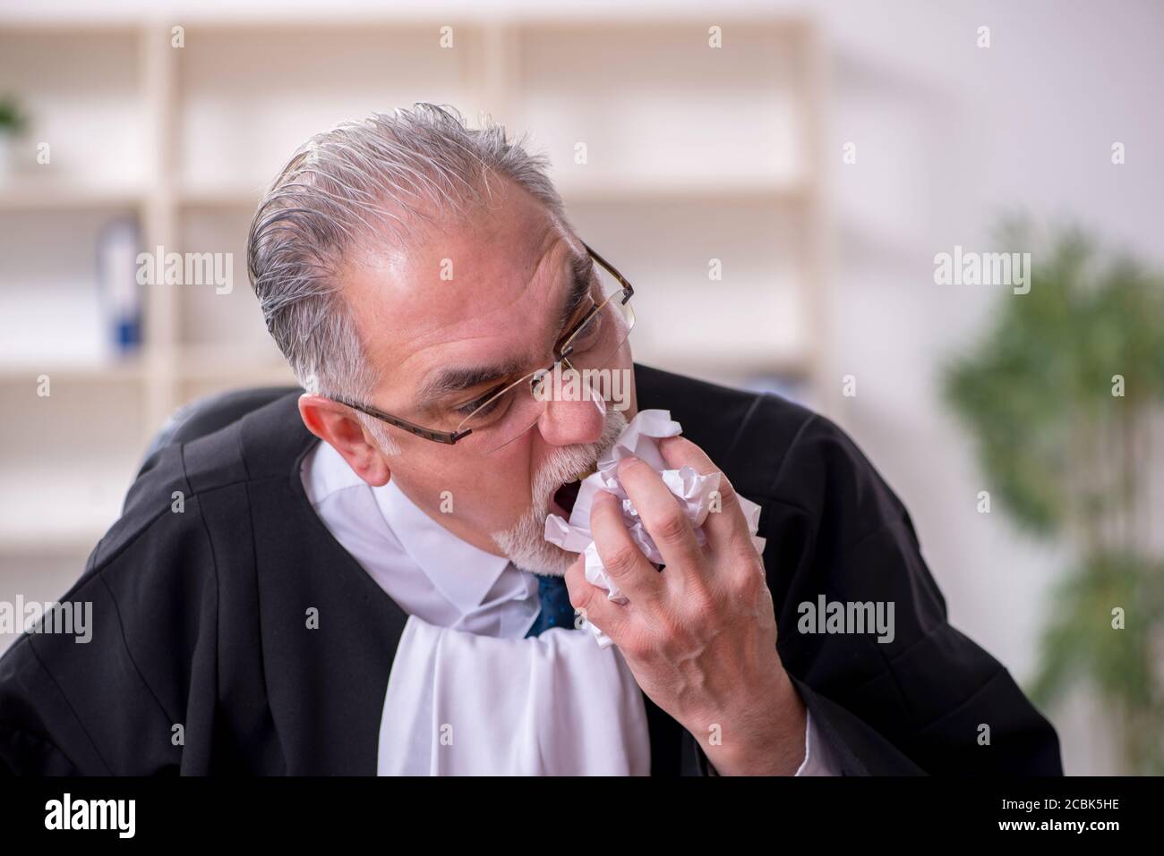 Old male judge working in the courthouse Stock Photo - Alamy