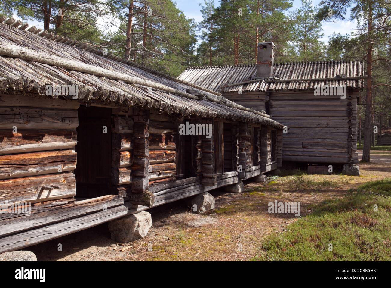 Wooden warehouses, farmhouse far out in rural country. Trees and forest ...