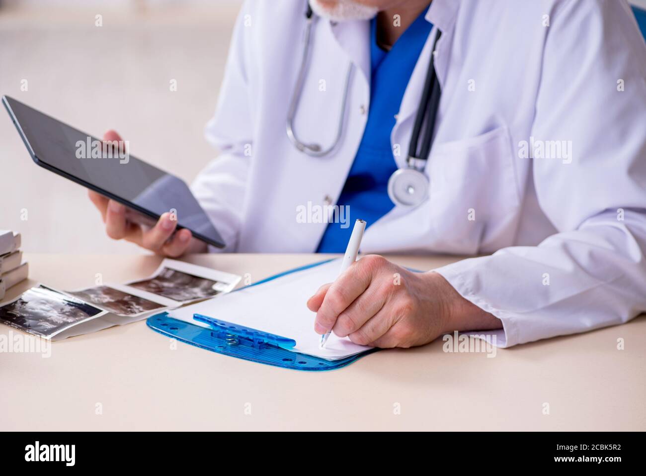 Telehealth doctor writing on hi-res stock photography and images - Alamy