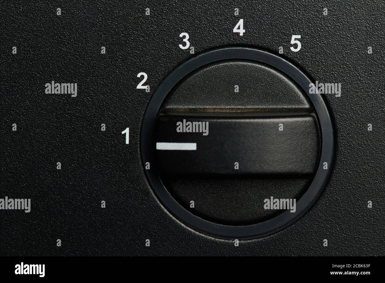 Dark metal circle control on gray dark background Stock Photo - Alamy