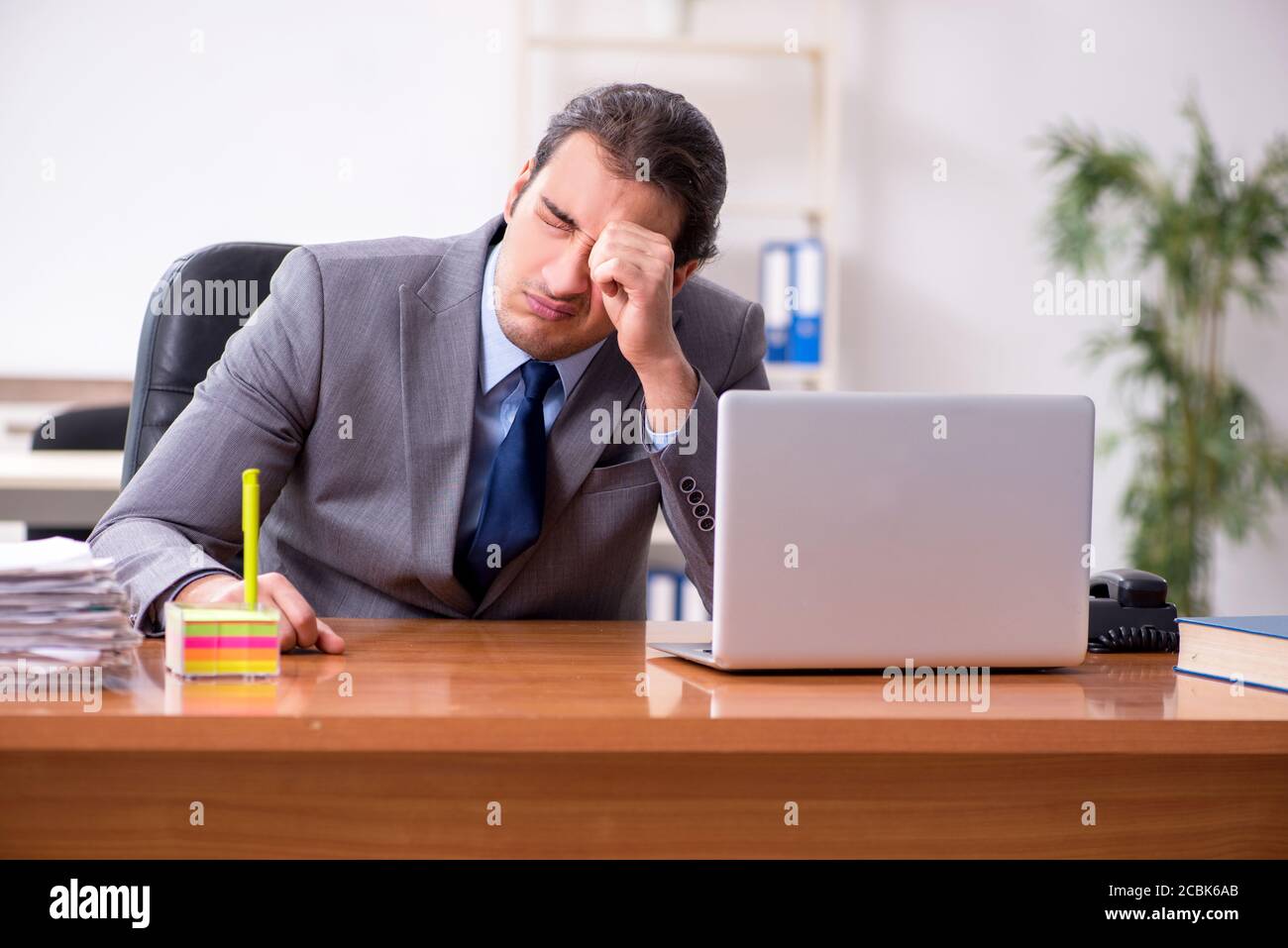 Young employee sleeping in the office Stock Photo - Alamy