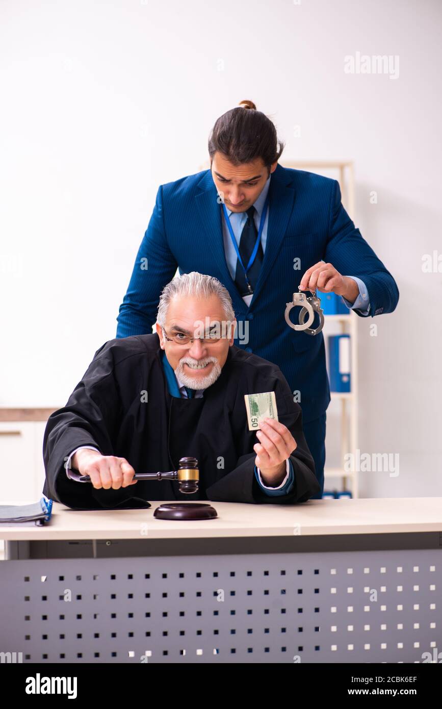 Police inspector arresting judge in court Stock Photo - Alamy