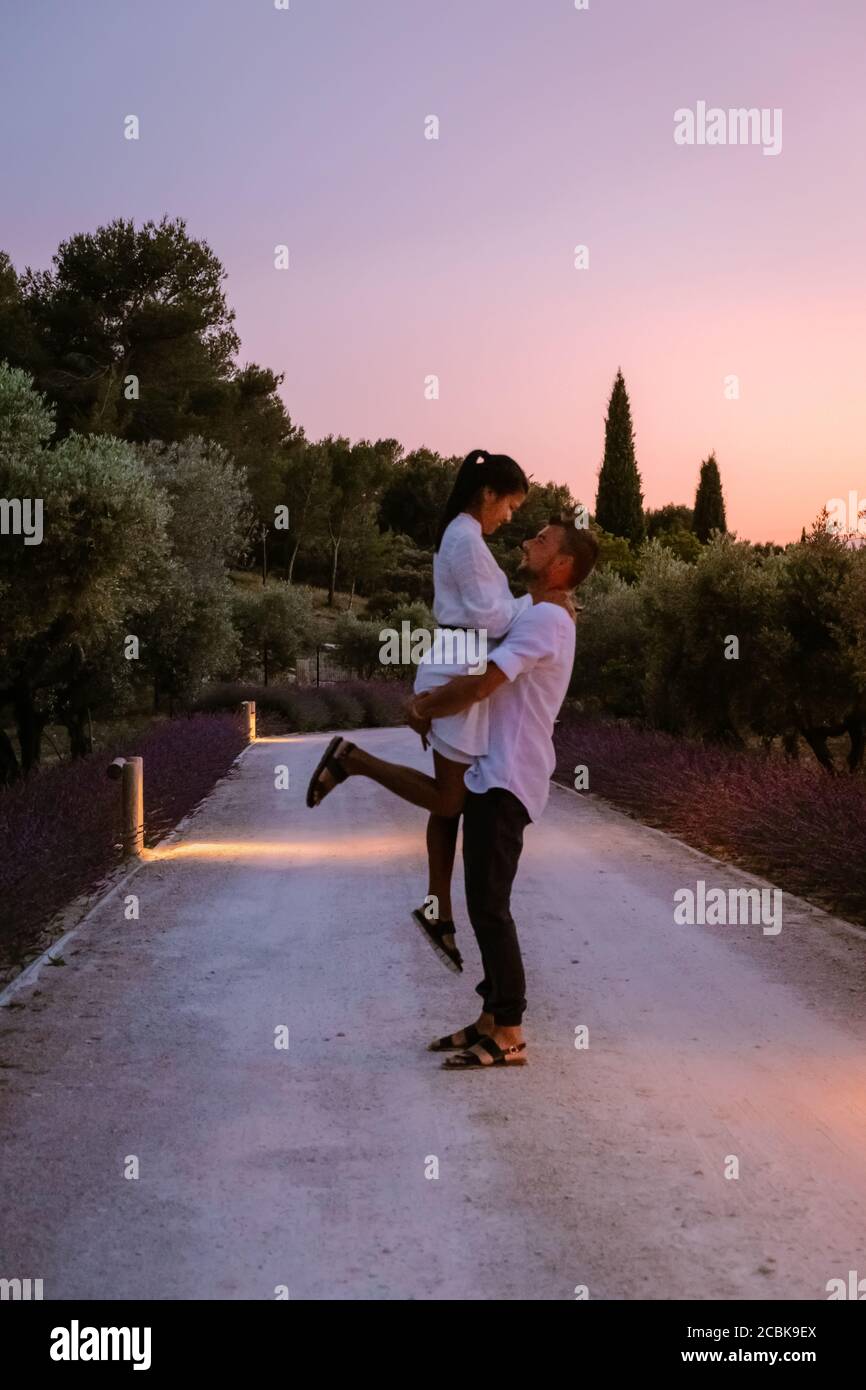 couple walking path with lavender during sunset in the Provence France ...