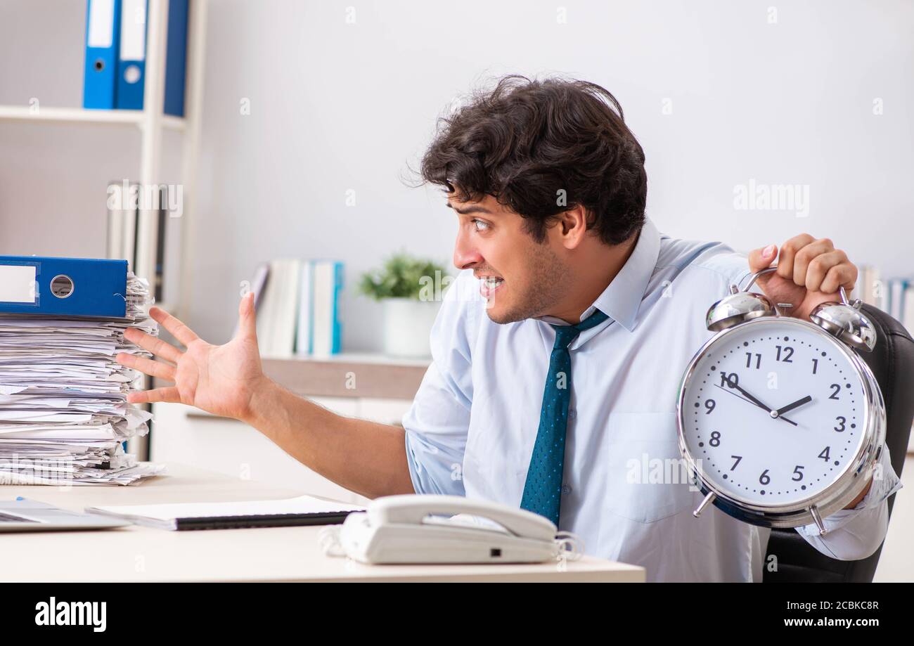 The overloaded busy employee with too much work and paperwork Stock ...