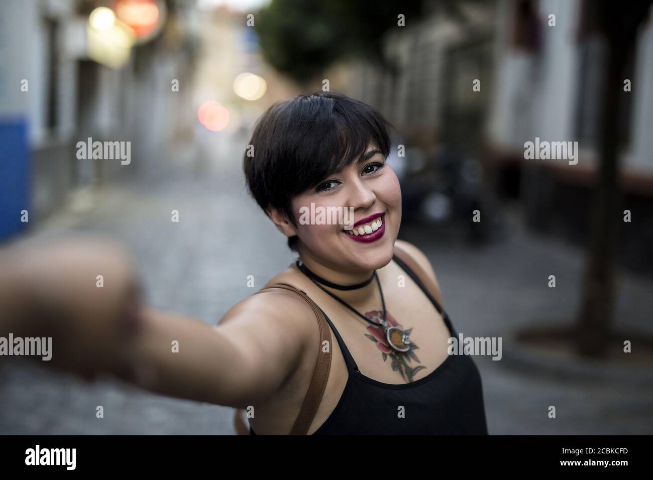 A shallow focus closeup shot of a Caucasian female in a town holding ...