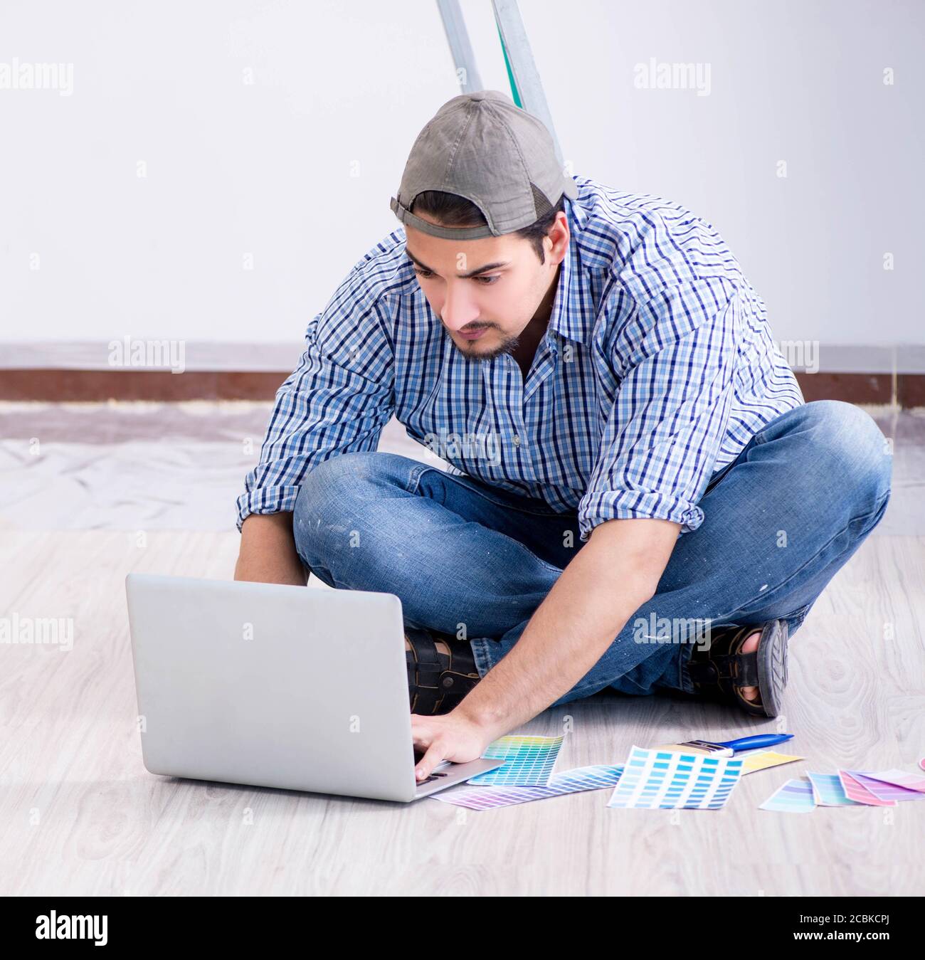The young man contractor choosing color from rainbow Stock Photo - Alamy