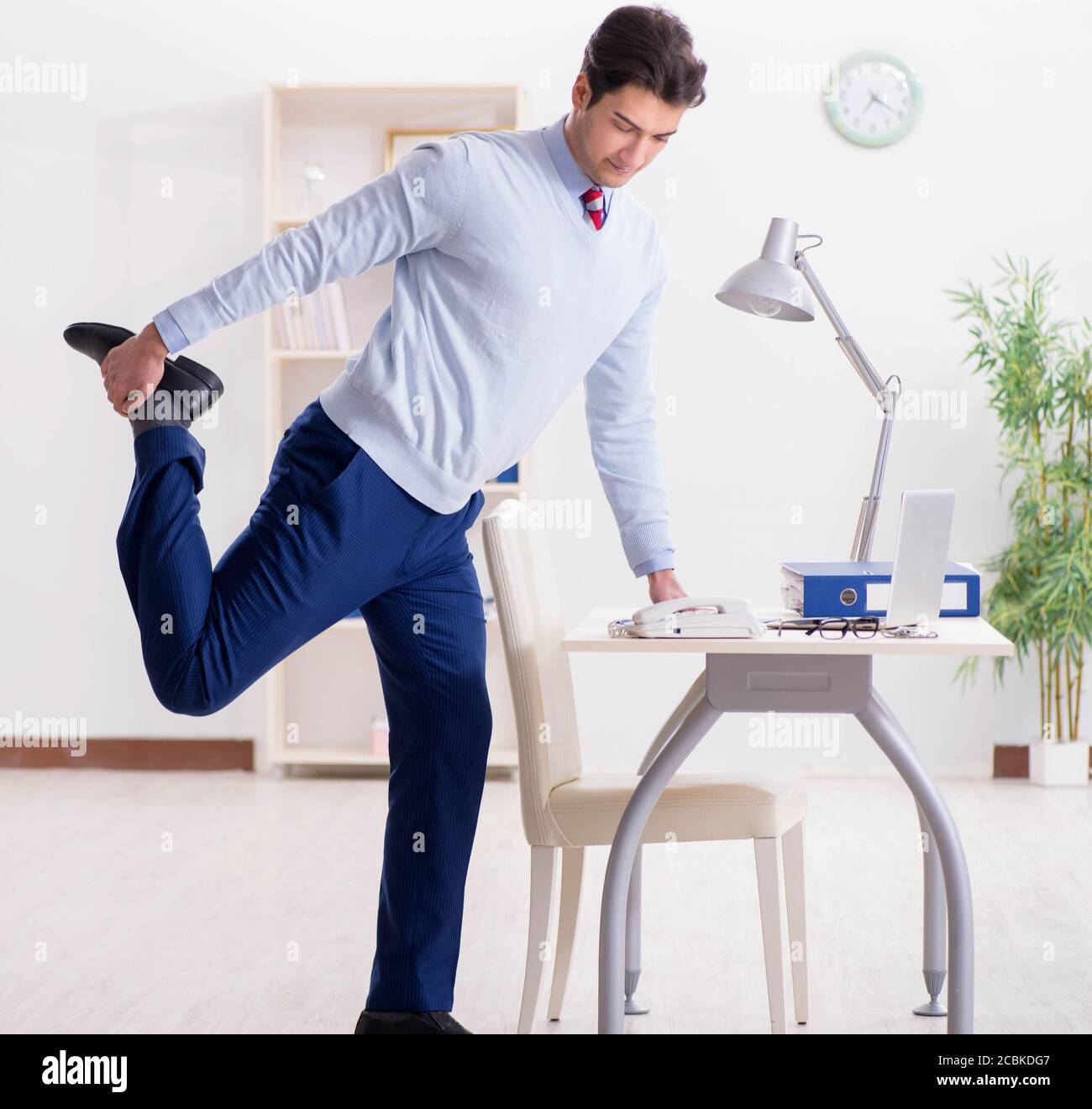 The employee doing stretching exercises in the office Stock Photo - Alamy