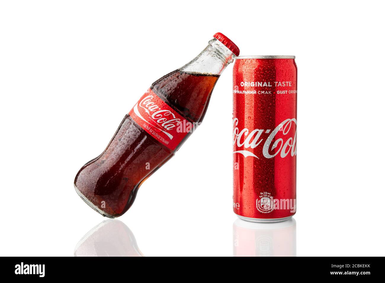Bottle and red can of Coca Cola drink with drops isolated on white ...