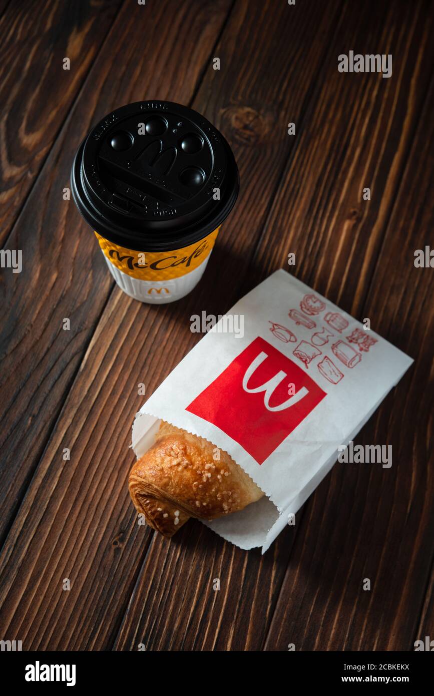 McDonald's restaurant. McCafe paper cup of coffee with croissant on ...