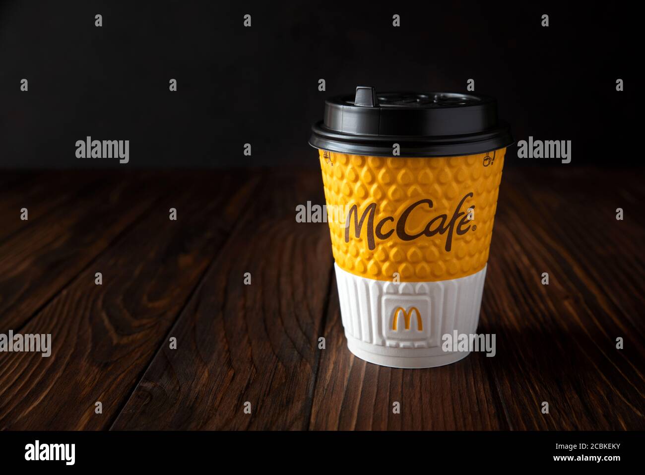 McDonald's restaurant. McCafe paper cup of coffee on dark wooden ...