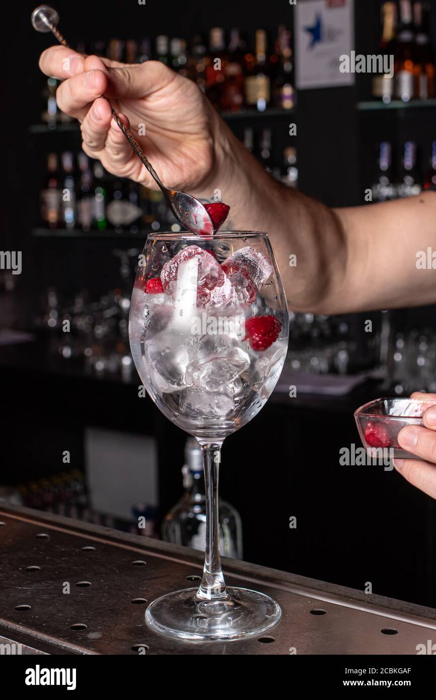 The bartender prepares a cocktail in the restaurant bar. The process of ...