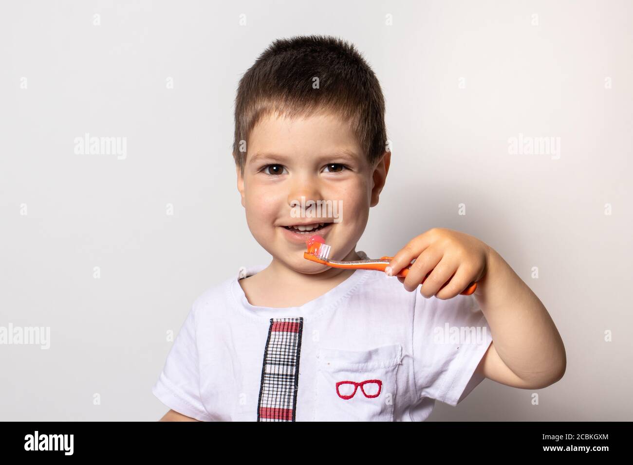 Cute little boy brushing teeth, isolated on white Stock Photo - Alamy