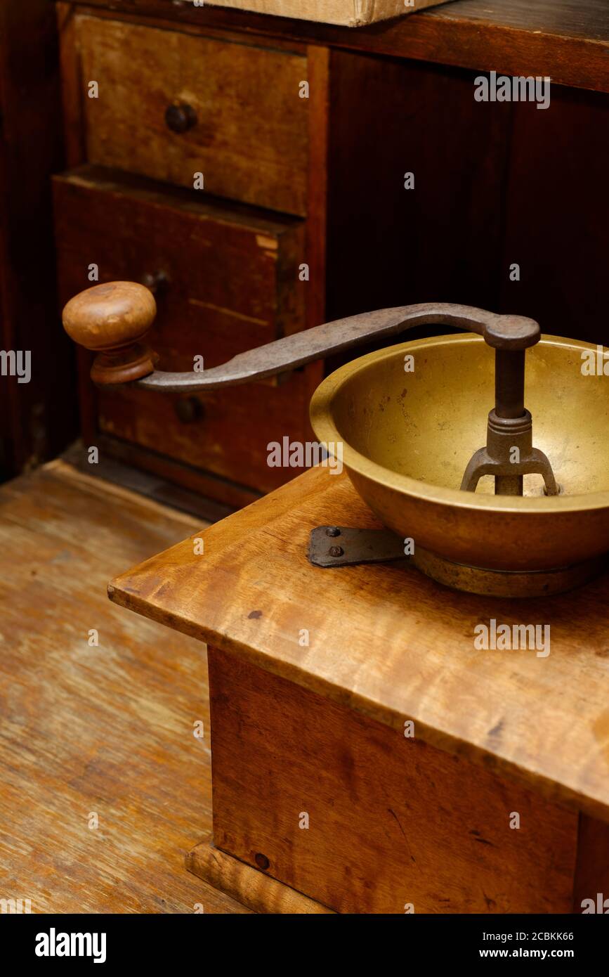 Antique aged manual wooden coffee grinder, kitchen interior, old drawer ...