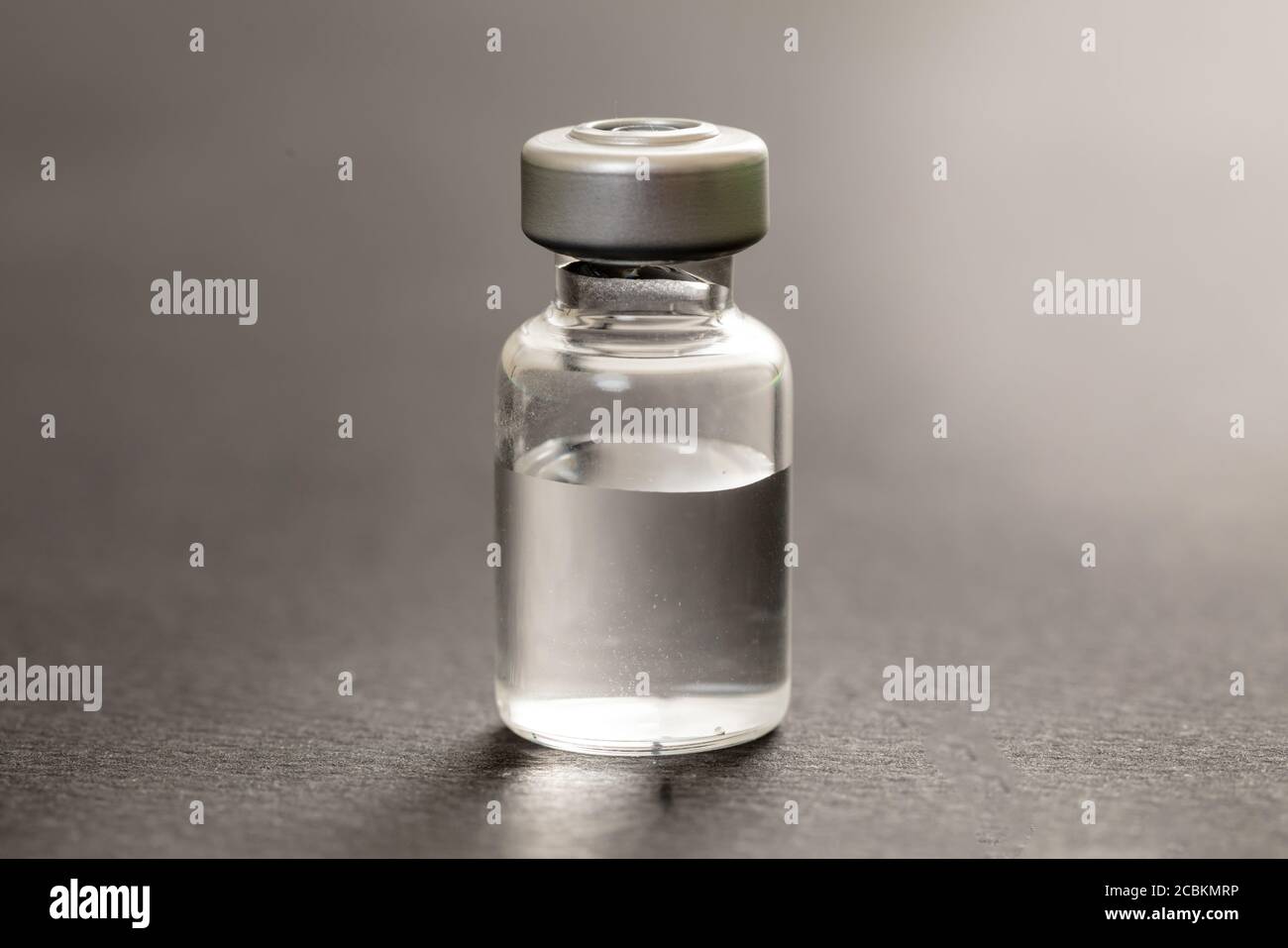 Medical vial for injection on gray background, transparent glass bottle ...