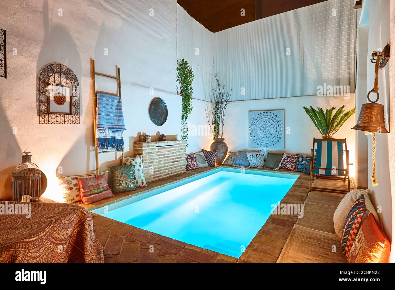 Swimming pool by night with turquoise water. Andalusian style. Spain ...