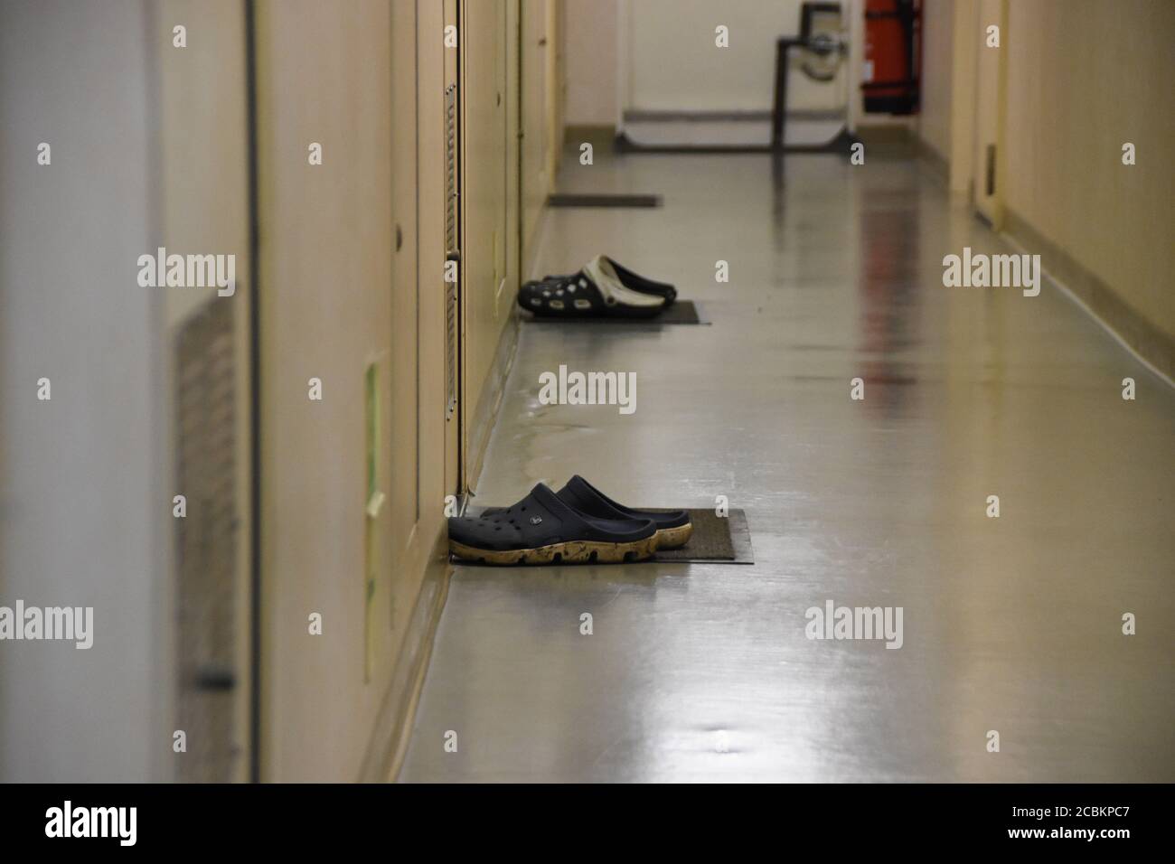 Neatly lying or laid protective slippers in waxing alleyway in front of ...