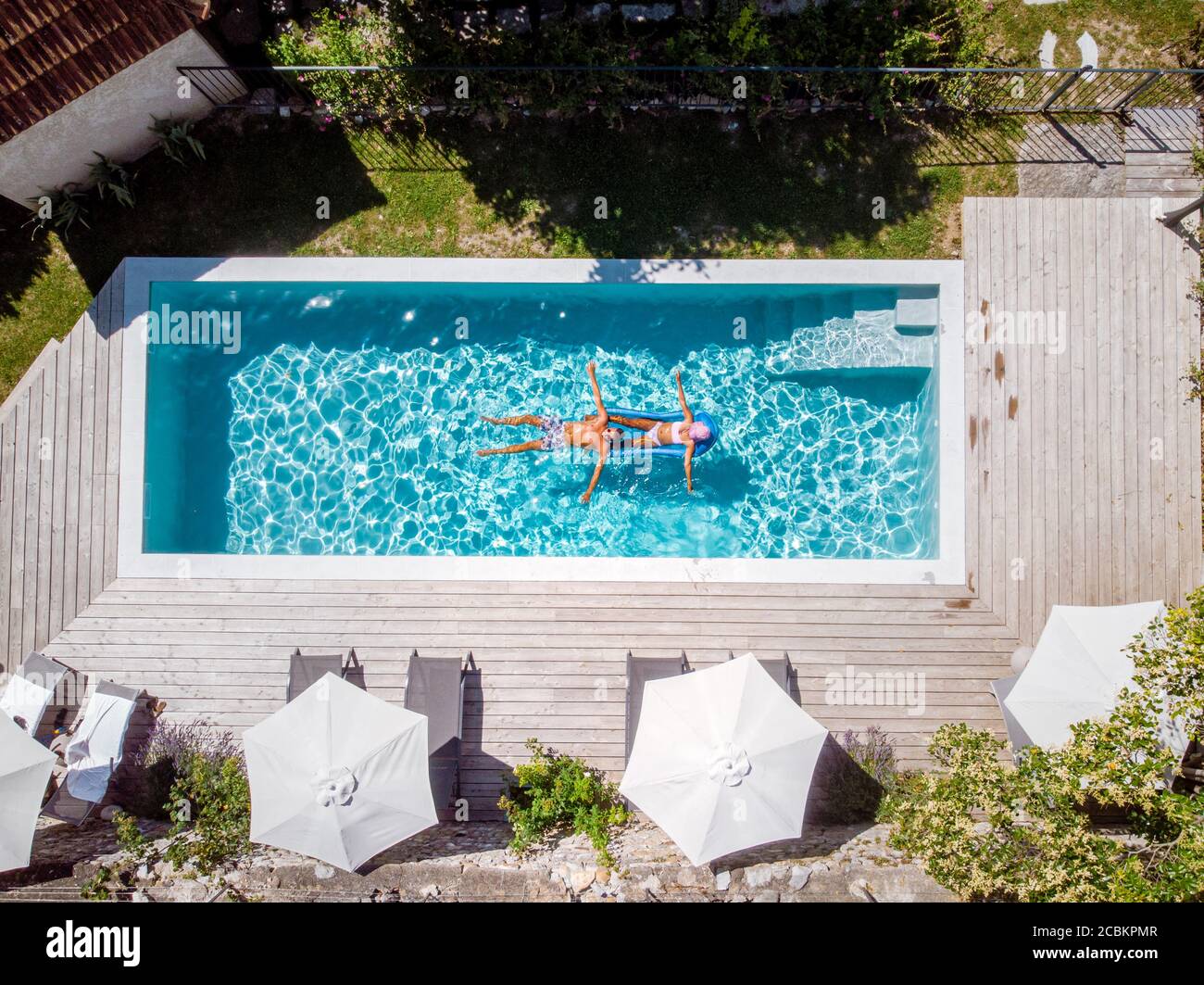two person swim in the pool at the hotel. View from above, couple men ...