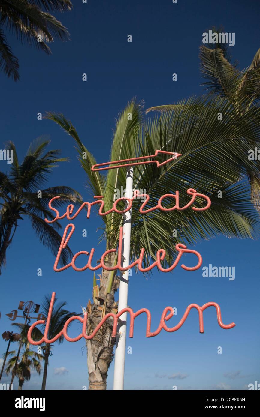 Womens restroom sign on beach Stock Photo - Alamy