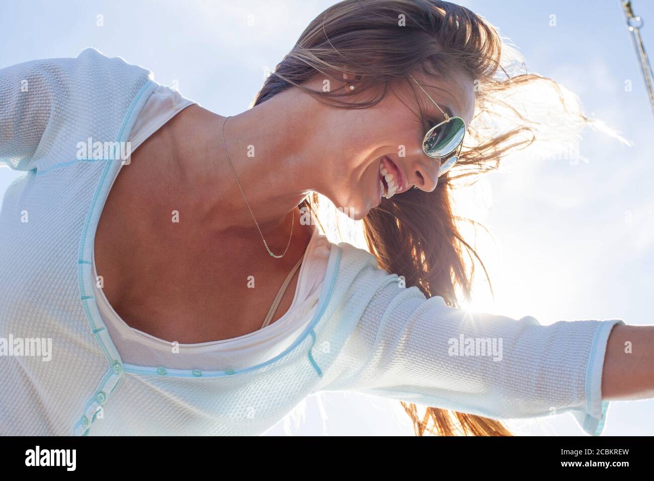 Woman on yacht laughing Stock Photo - Alamy
