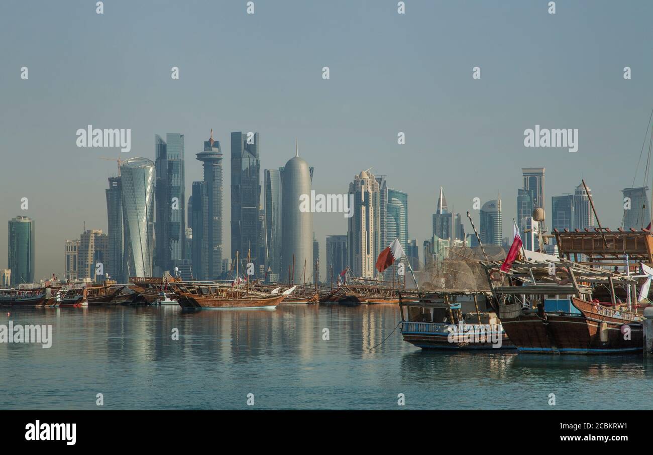 Boats and downtown Doha across water, Doha, Qatar Stock Photo - Alamy